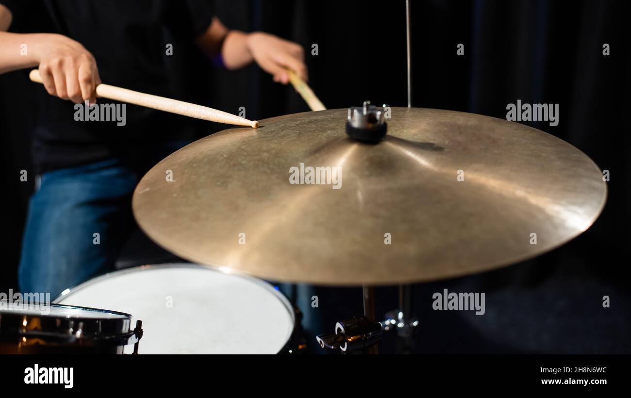 Close-up of drumsticks on a cymbal drum Stock Photo - Alamy