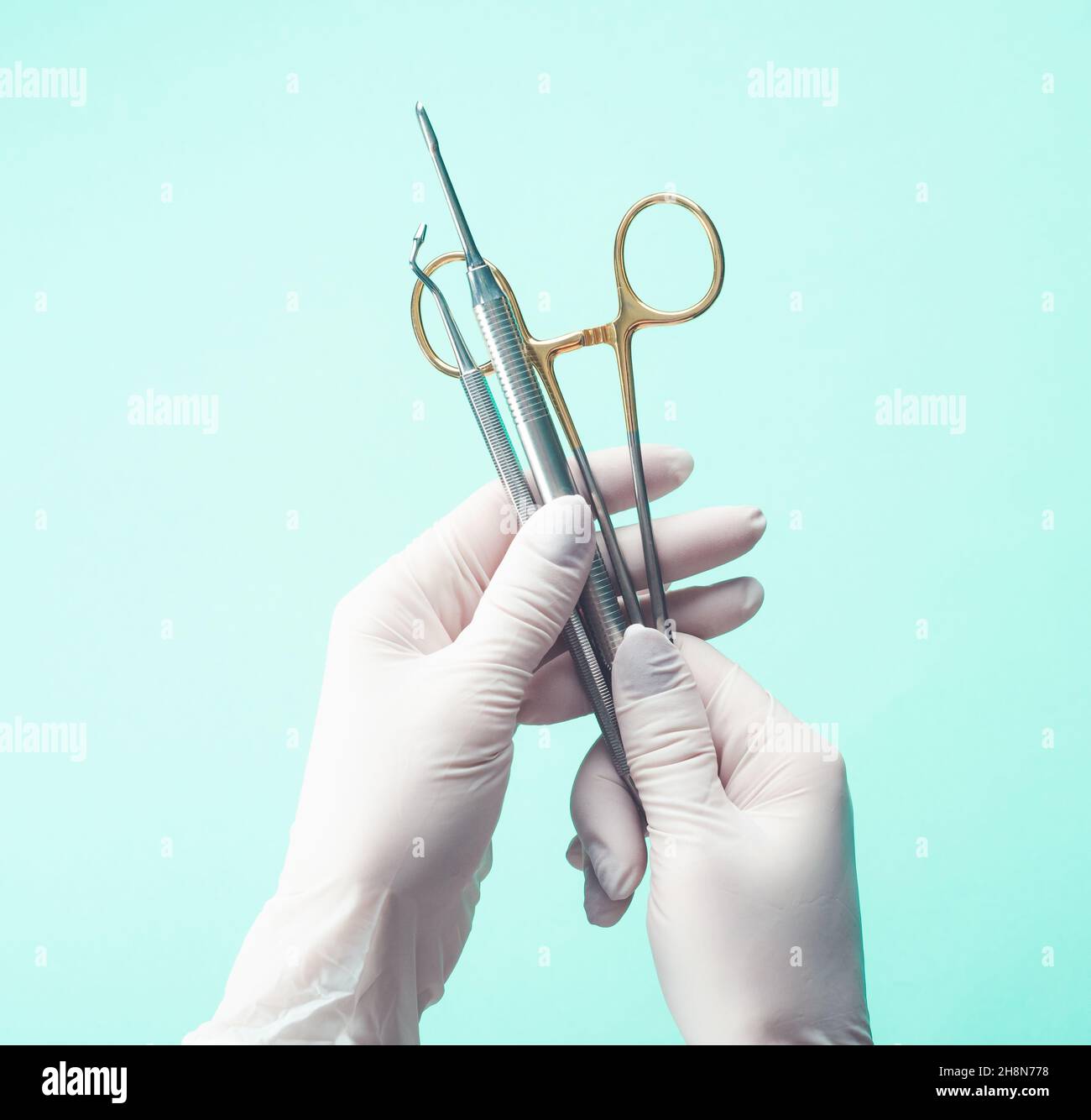 Hands in gloves holding medical tools Stock Photo - Alamy