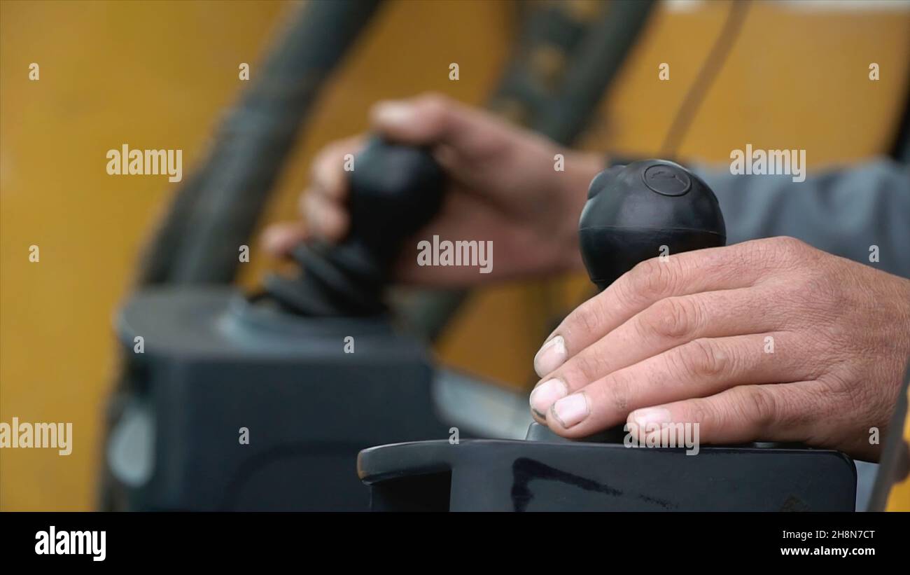 Detailing of the new driver cab excavator. Clip. Driver of the crane ...