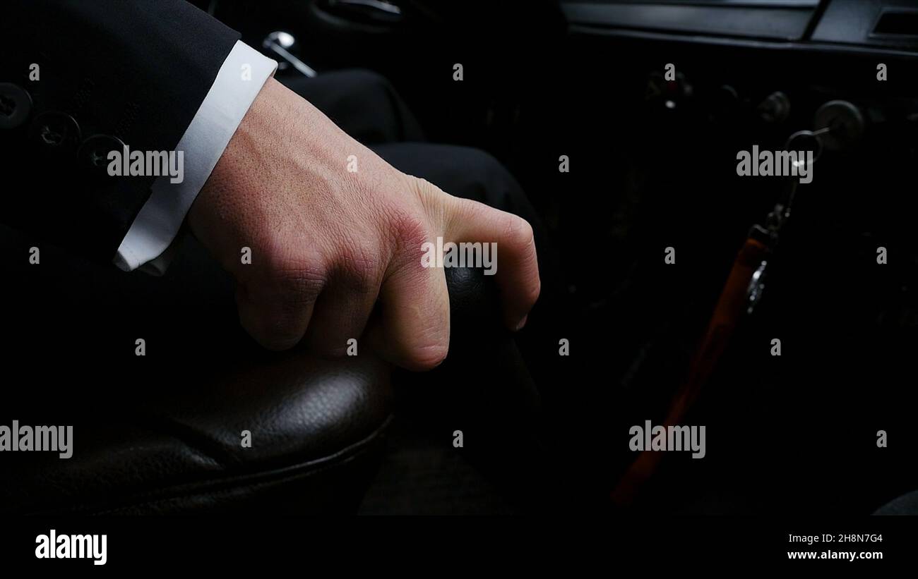 Businessman driving to work, hand shifting the gear stick. Businessman ...