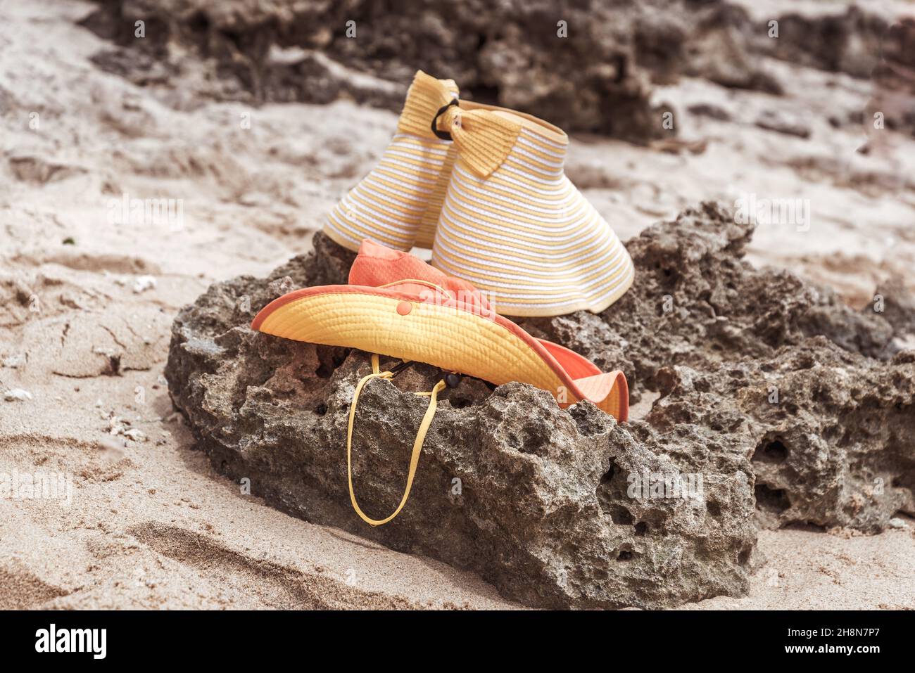 Stones on beach and hat Stock Photo - Alamy