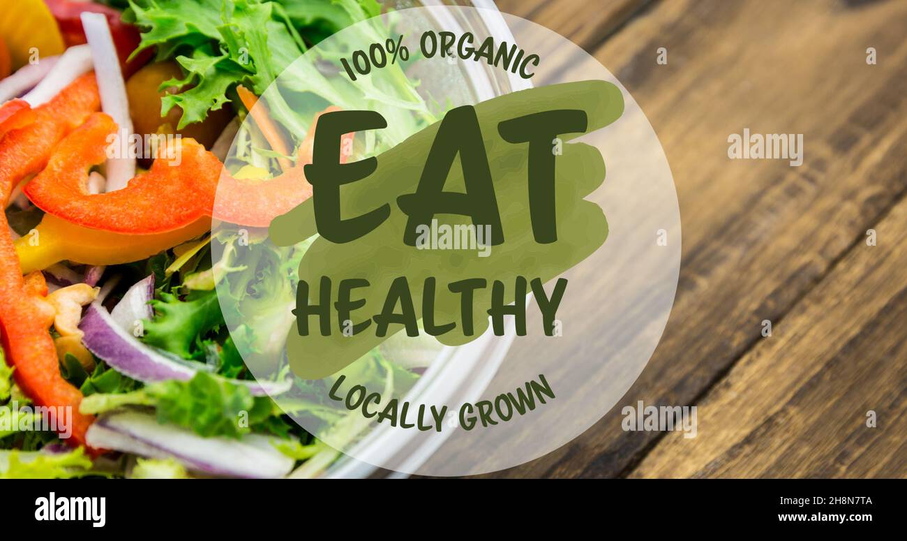 Eat healthy 100 percent organic locally grown symbol on fresh salad on ...