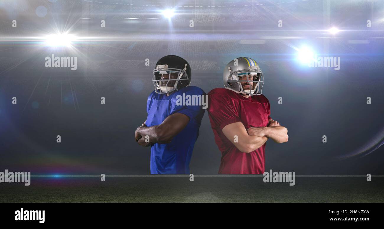 Portrait of rival american football players standing back to back with ...