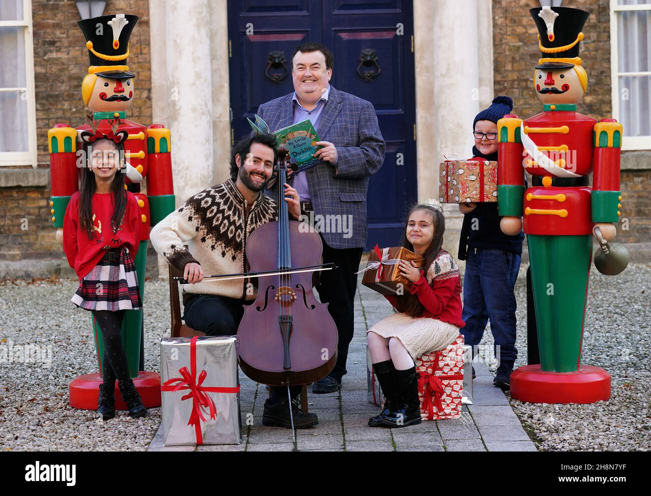 Cellist Patrick Dexter with (from left) Ingrid Nistor (7), Minister of ...