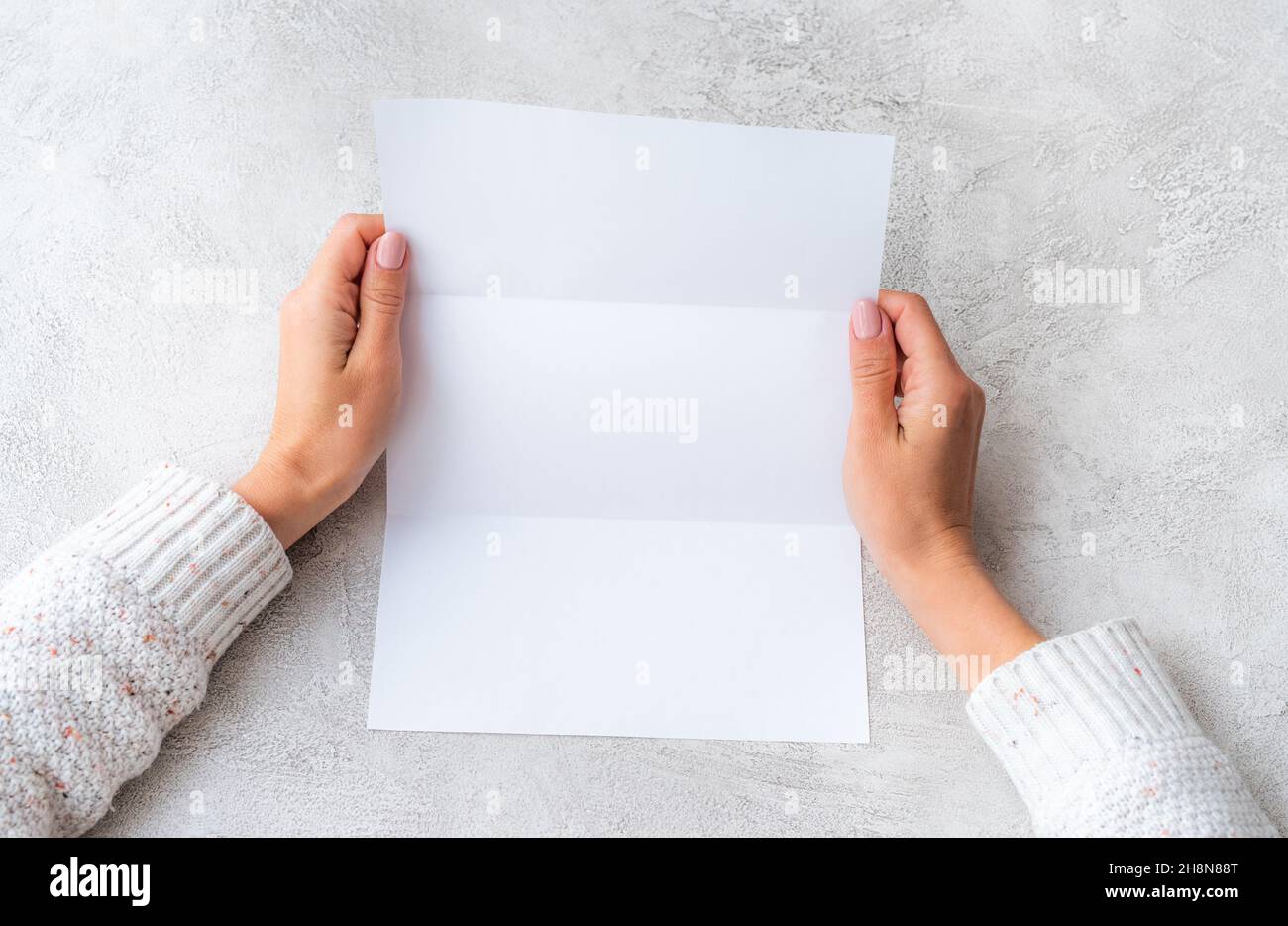 Person holding a4 paper hi-res stock photography and images - Alamy