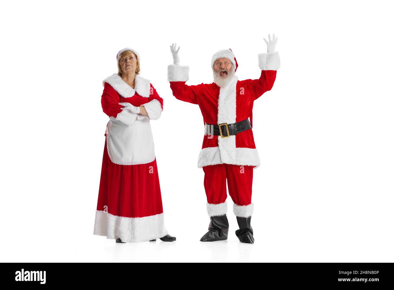 Excited senior man and beautiful woman, Santa Claus and missis Claus in ...