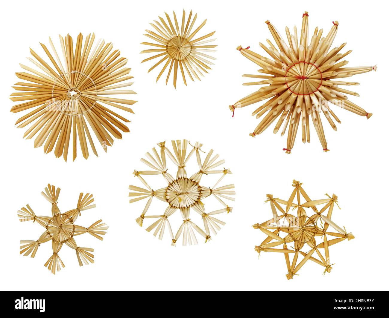 Set of different hand made straw stars isolated on white background ...
