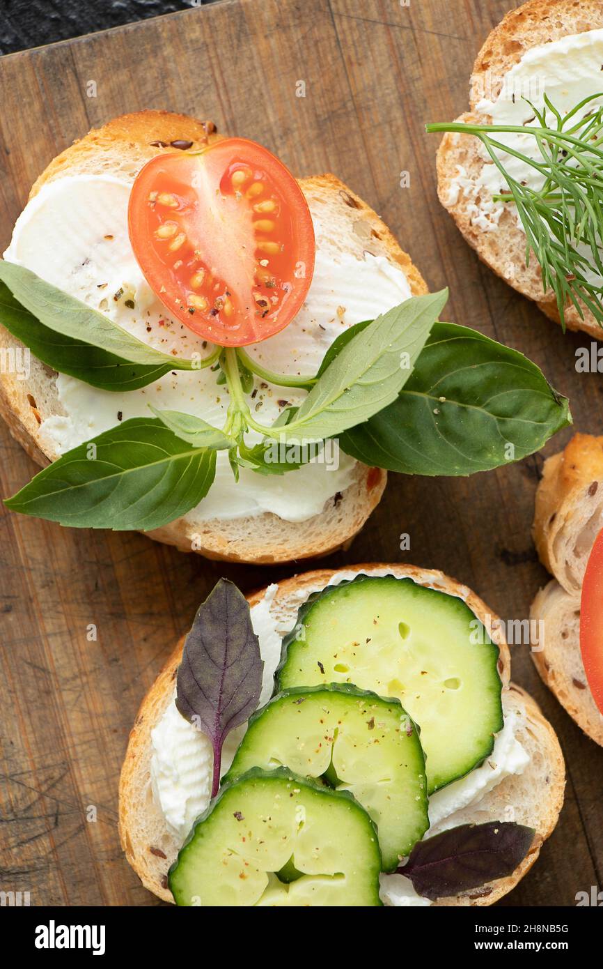 vertical photo with closeup various vegetable sandwiches with cream ...