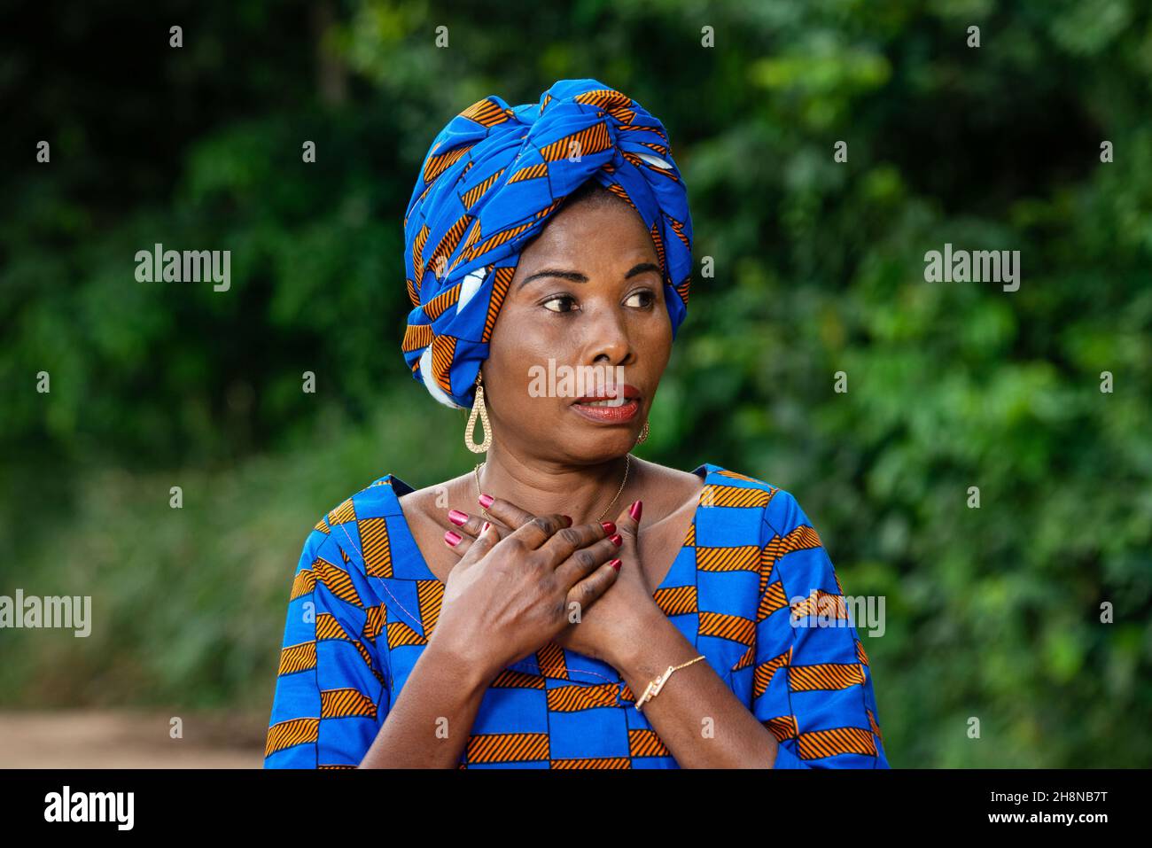Woman holding chest in fear hi-res stock photography and images - Alamy