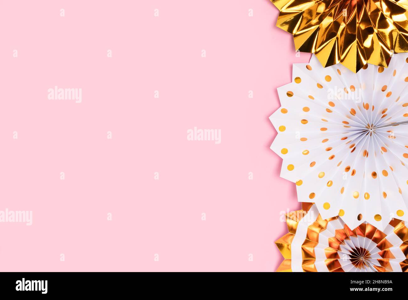 Frame made of gold colored paper fans on a pink background. Festive ...