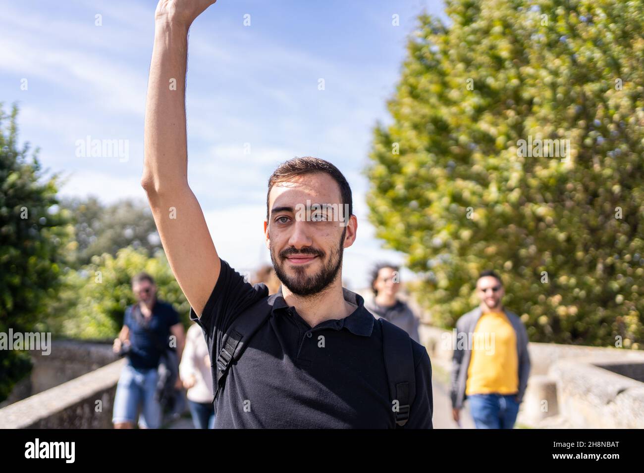 Selective focus on a tour guide leading a group of tourist during the ...