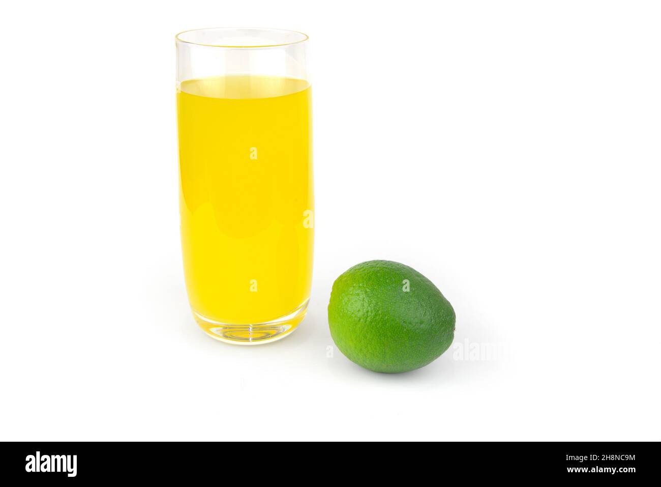 lime and glass of juice isolated on white Stock Photo - Alamy