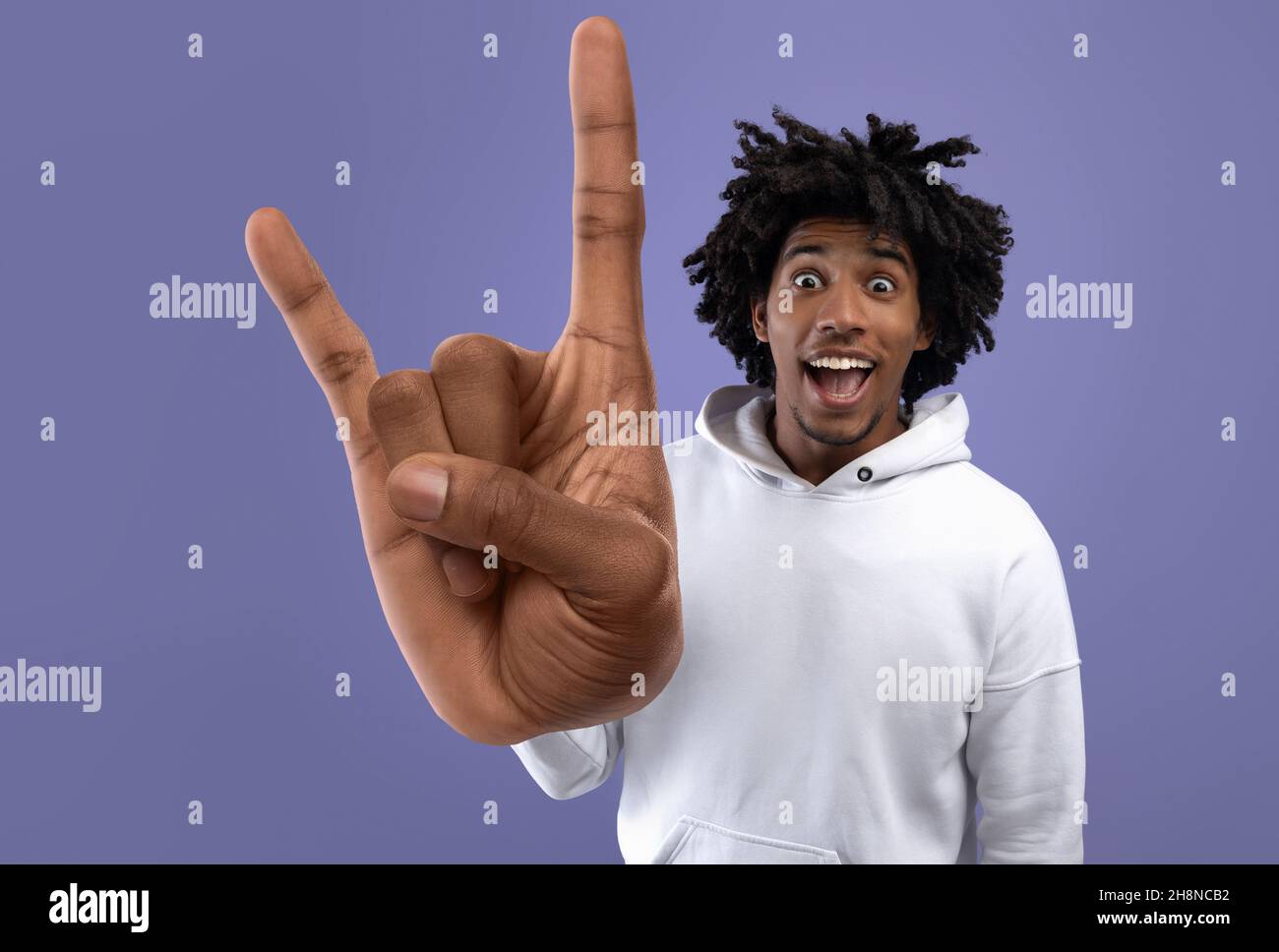 Cheerful african american guy showing hand-horns gesture Stock Photo ...