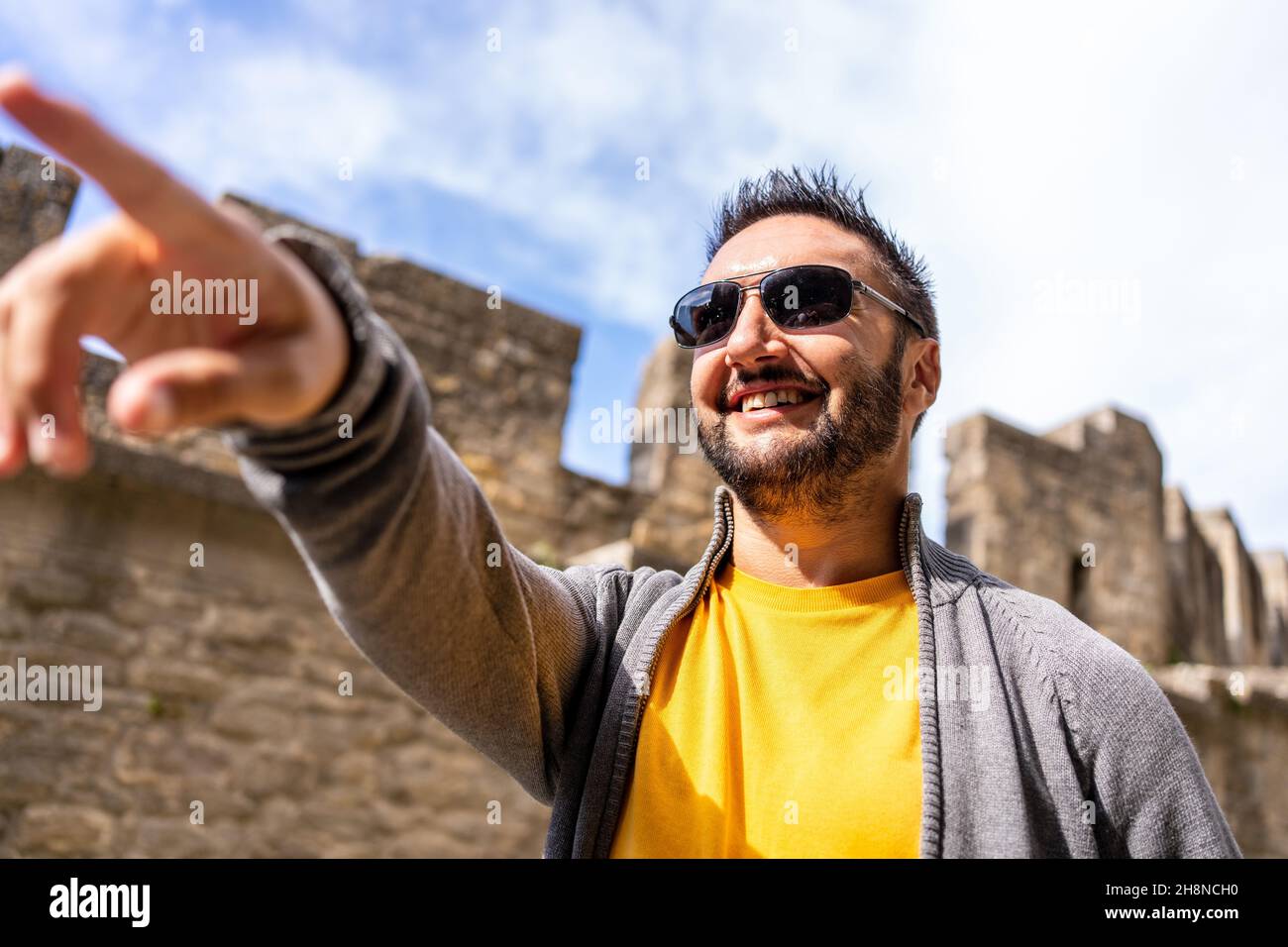 Close up view of a man pointing forward standing in a medieval castle ...