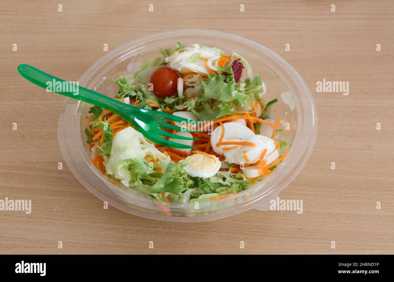 Industrial mixed salad with boiled egg, surimi, cherry tomato, grated ...