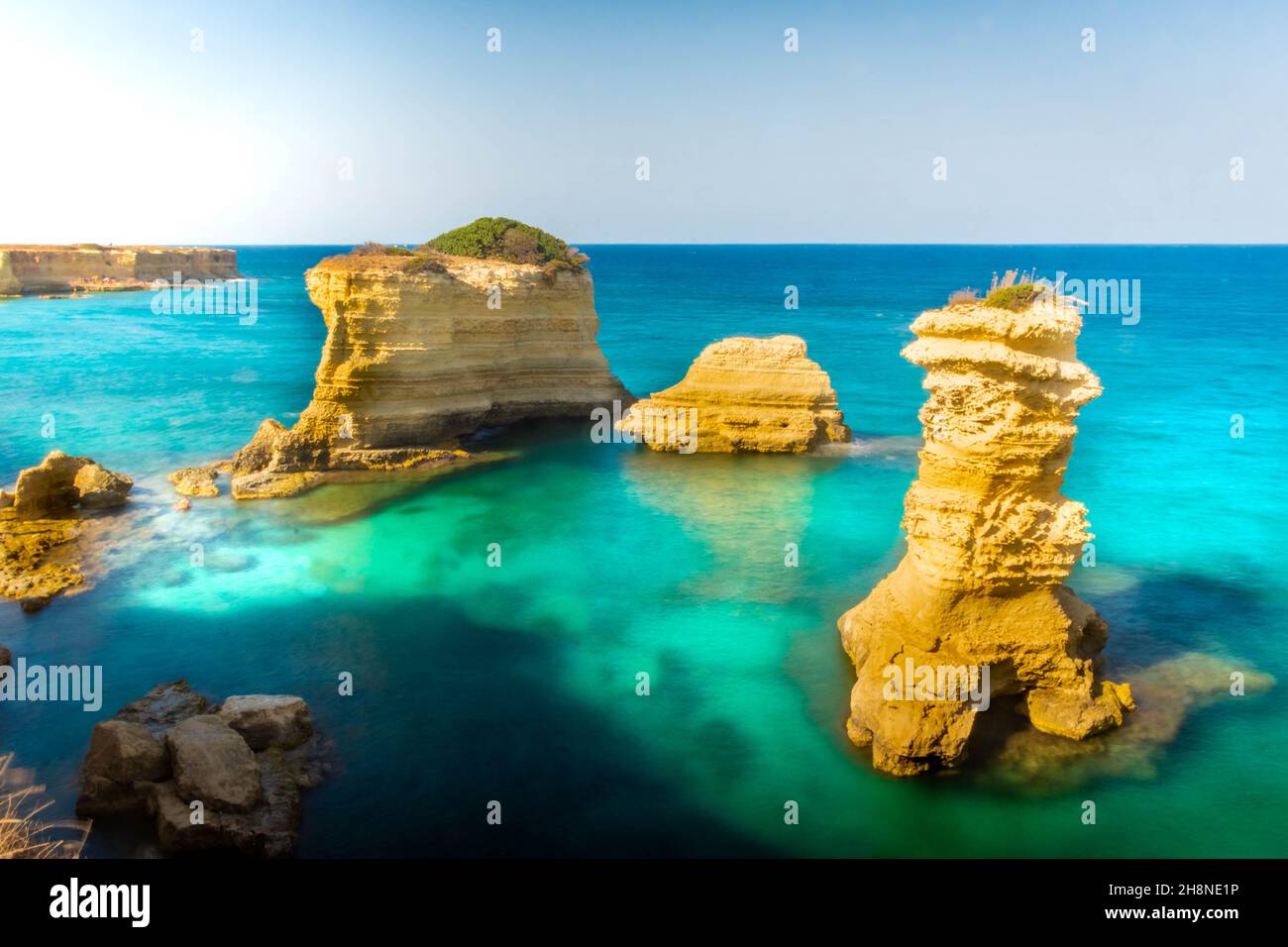 Beautiful cliffs and sea stacks of Sant'Andrea on the crystal clear ...