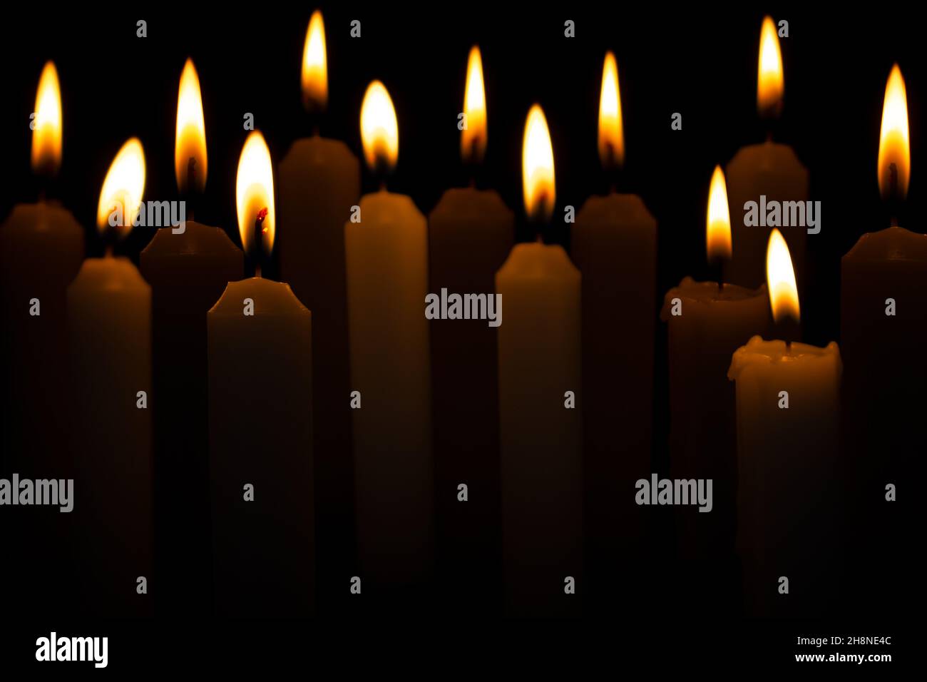 Burning candles on a black background. Ritual rites Stock Photo - Alamy