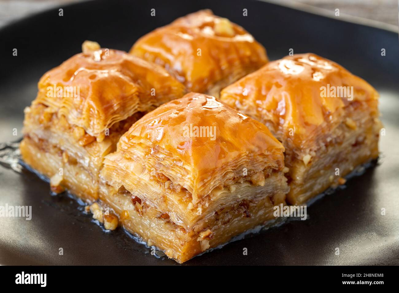 Walnut Baklava on wooden background. Turkish style walnut baklava ...