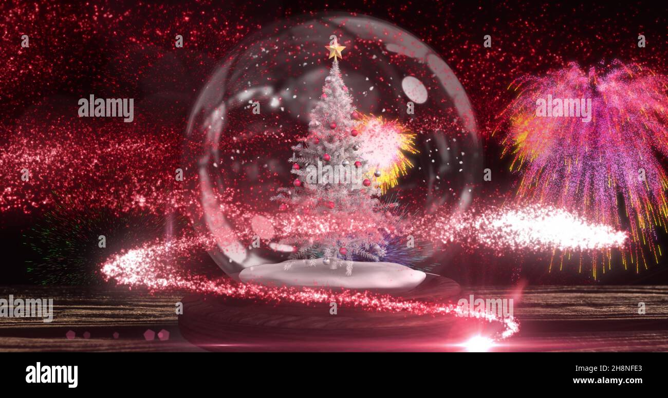 Image of decorated christmas tree in snow globe and colourful fireworks ...