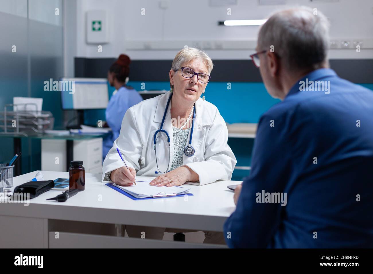 Doctor giving patient documents hi-res stock photography and images - Alamy