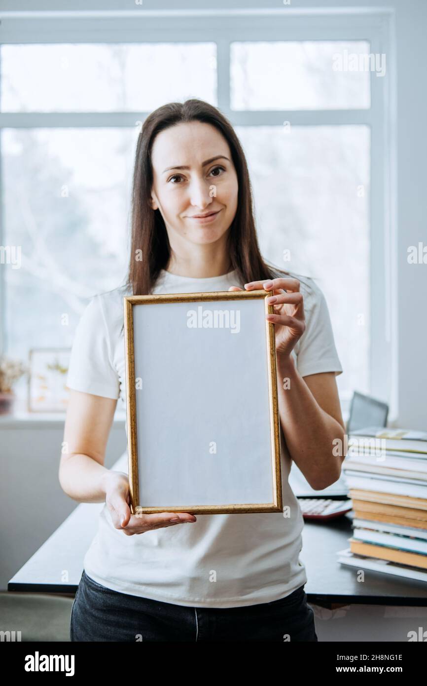 Frame picture, poster, diploma, certificate mockup in female hands ...