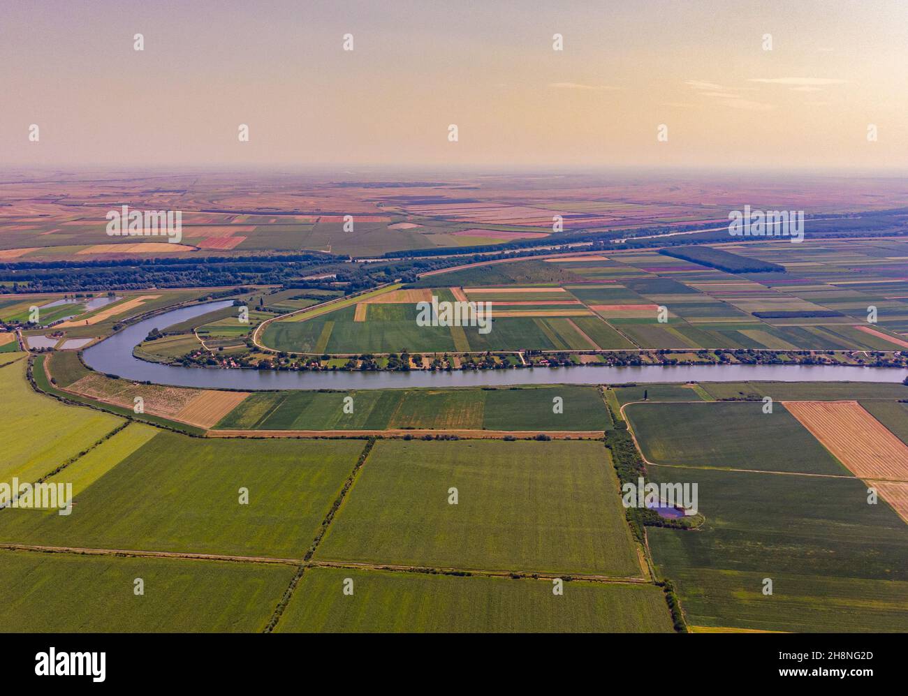 Birds-eye view of land and the Tisa river flowing through it in Serbia ...