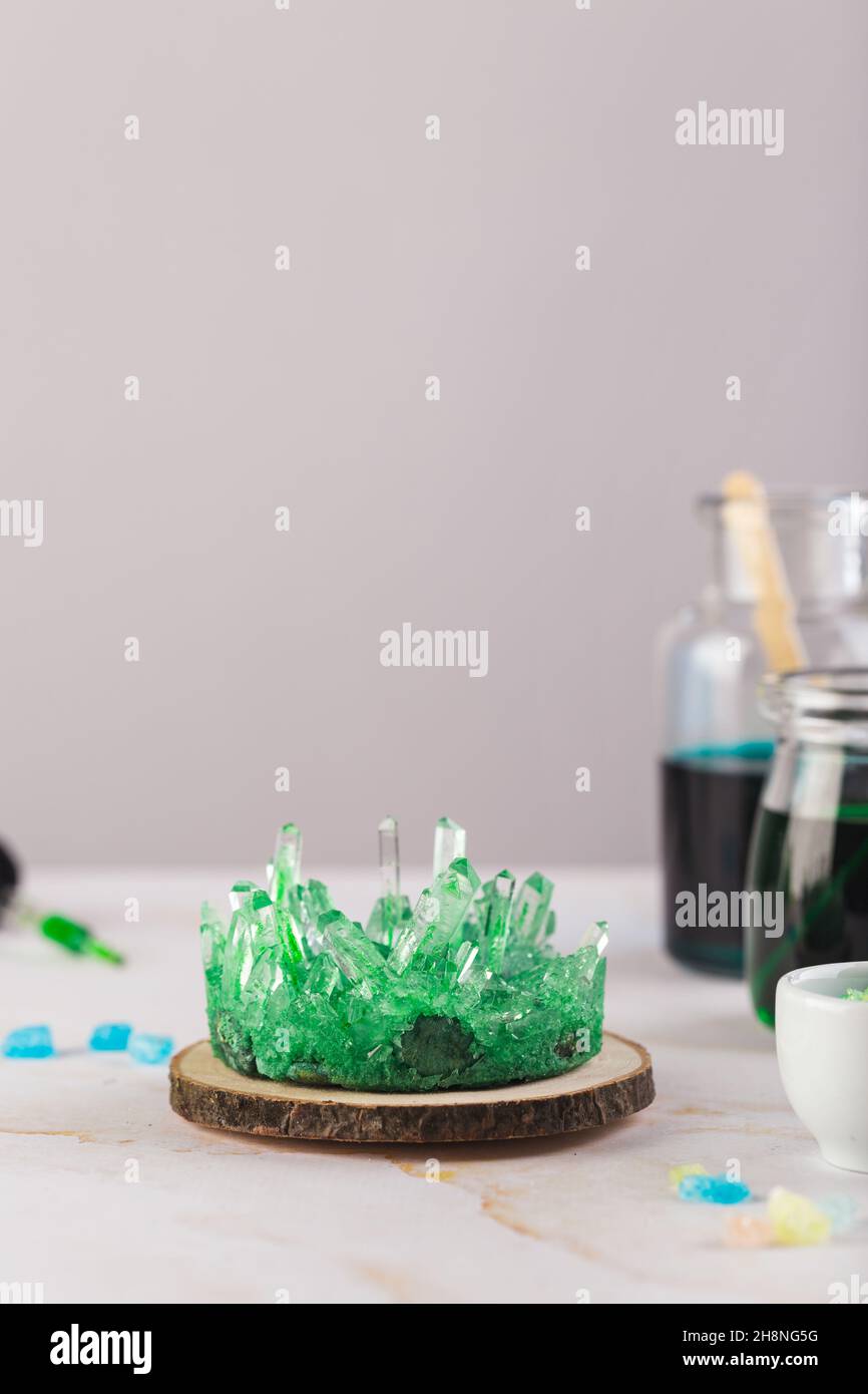 Green crystal grown by a child. Science is fun concept. Experiment with ...