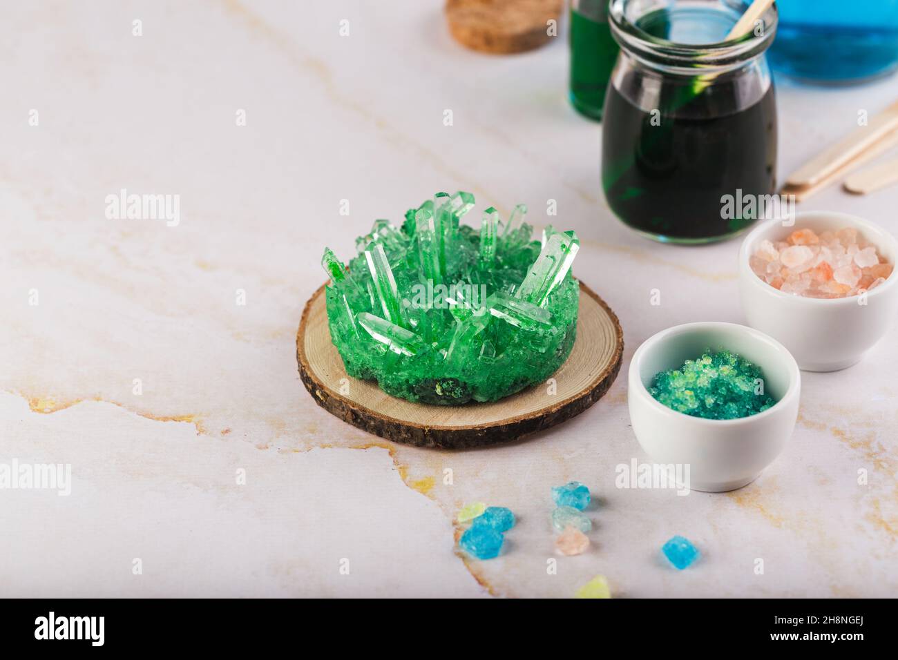 Green crystal grown by a child. Science is fun concept. Experiment with ...