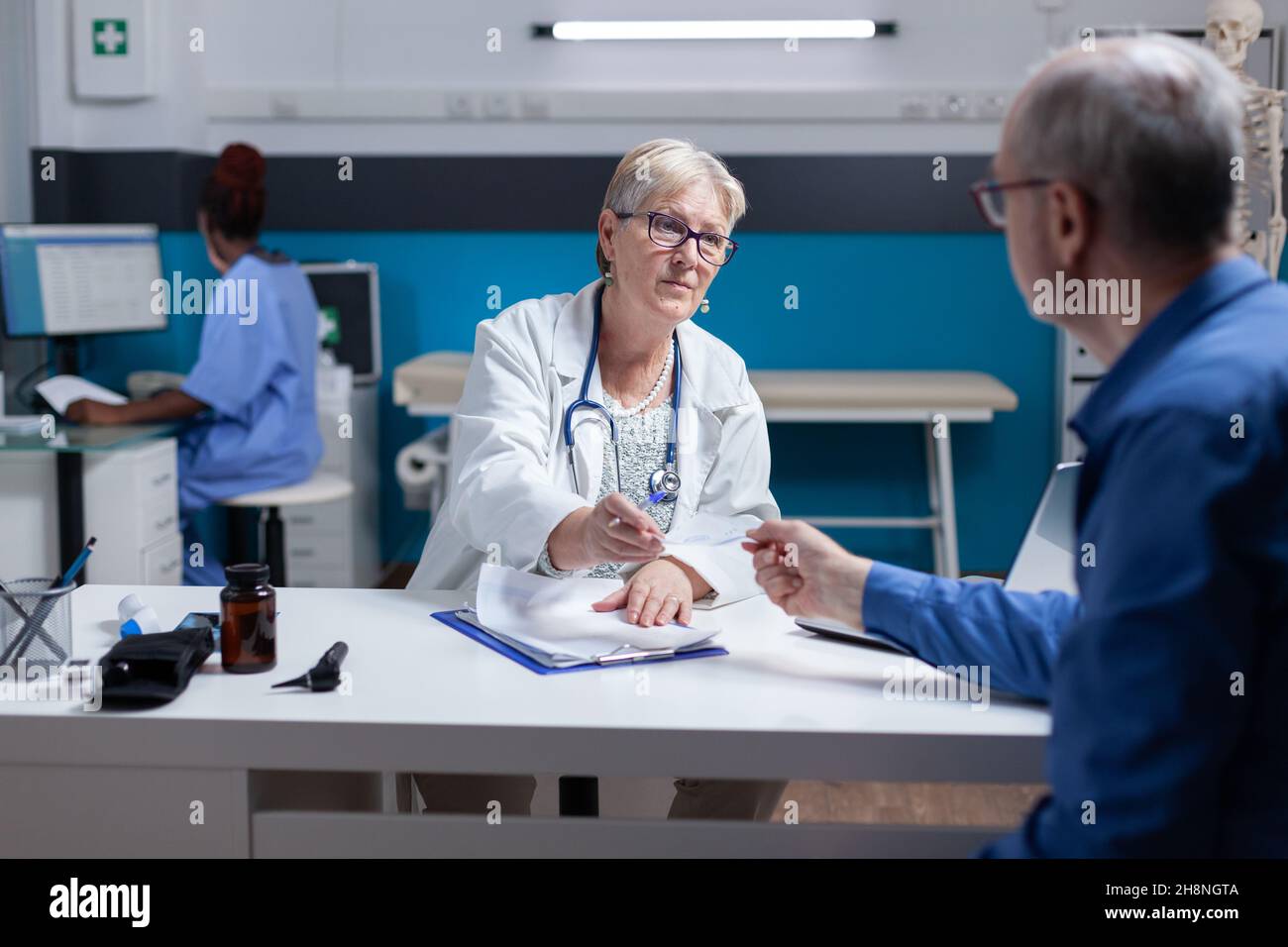 Medical specialist giving prescription paper with treatment to sick ...