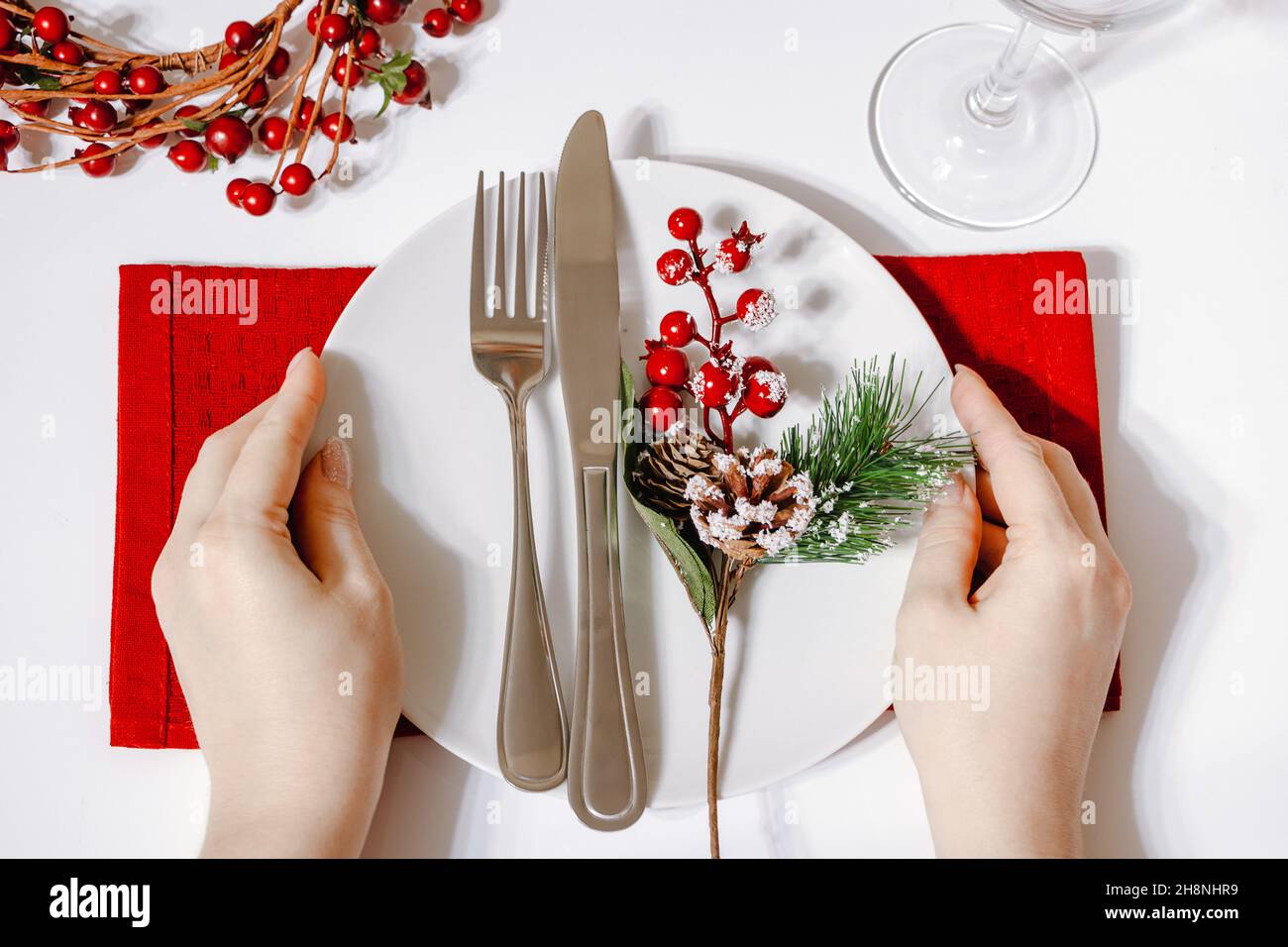 Woman serves Christmas table. Female hands hold plate with cutlery ...