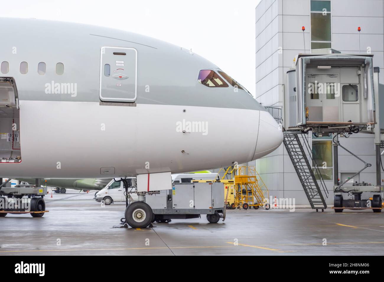 Side view of the nose and landing gear of a passenger airliner near the ...