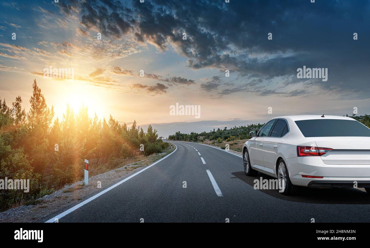 Car is driving along the road. White car on a suburban highway Stock ...