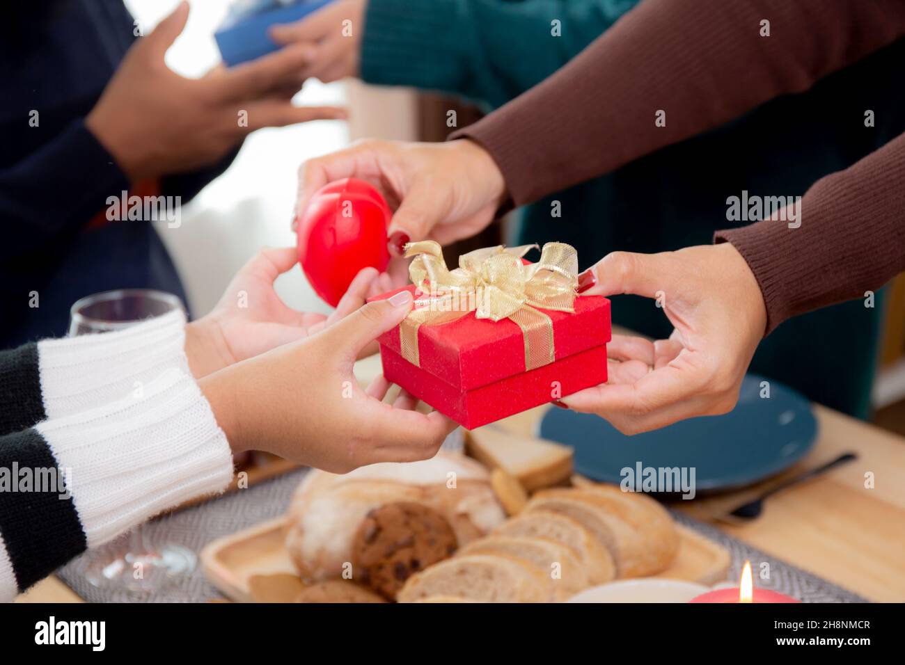Happy family with daughter giving gift box with father and mother ...