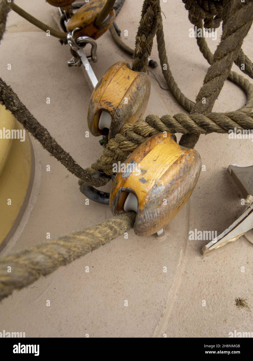 Vertical shot of the ropes on the borders of the deck of an old ship ...