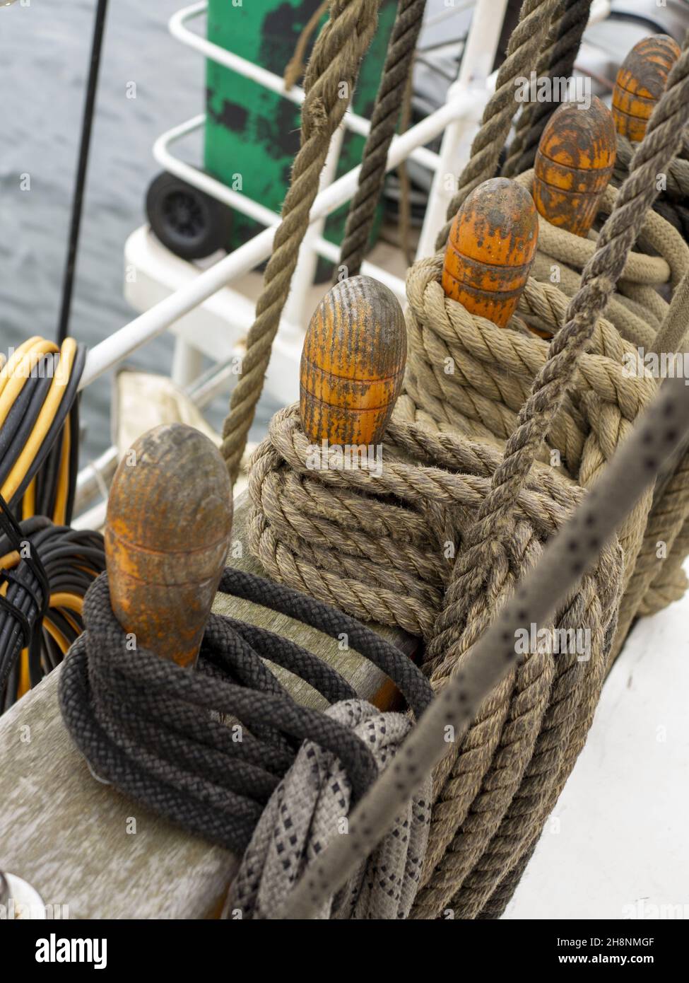 Vertical shot of the ropes on the borders of the deck of an old ship ...
