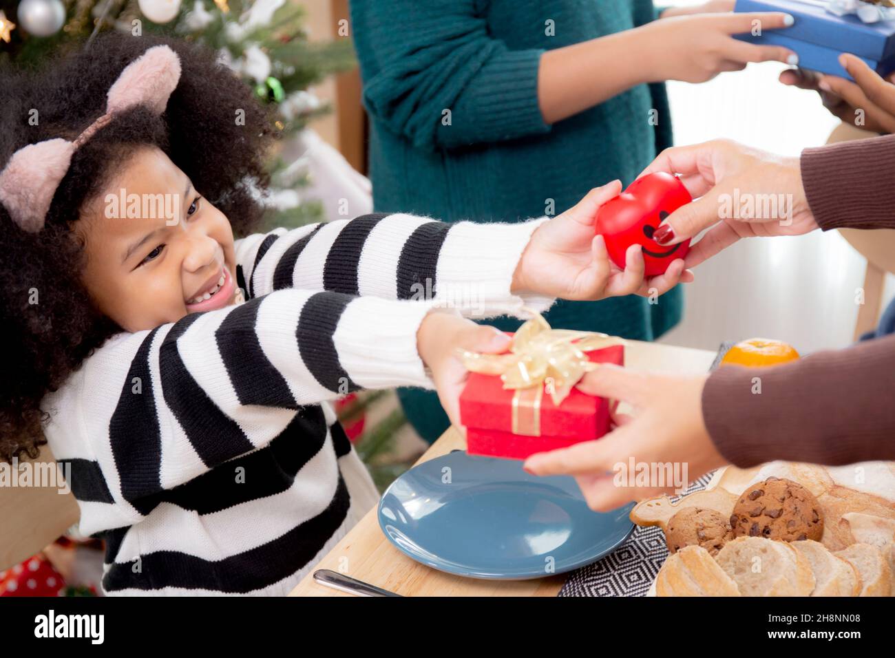 Happy family with father and mother giving gift box with daughter ...