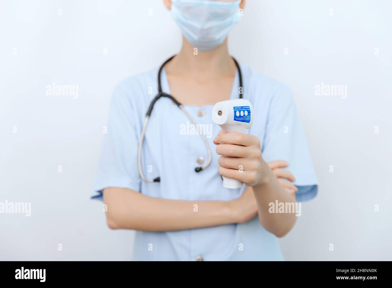 Temperature measurement gun in doctor hands. Close-up shot of doctor ...