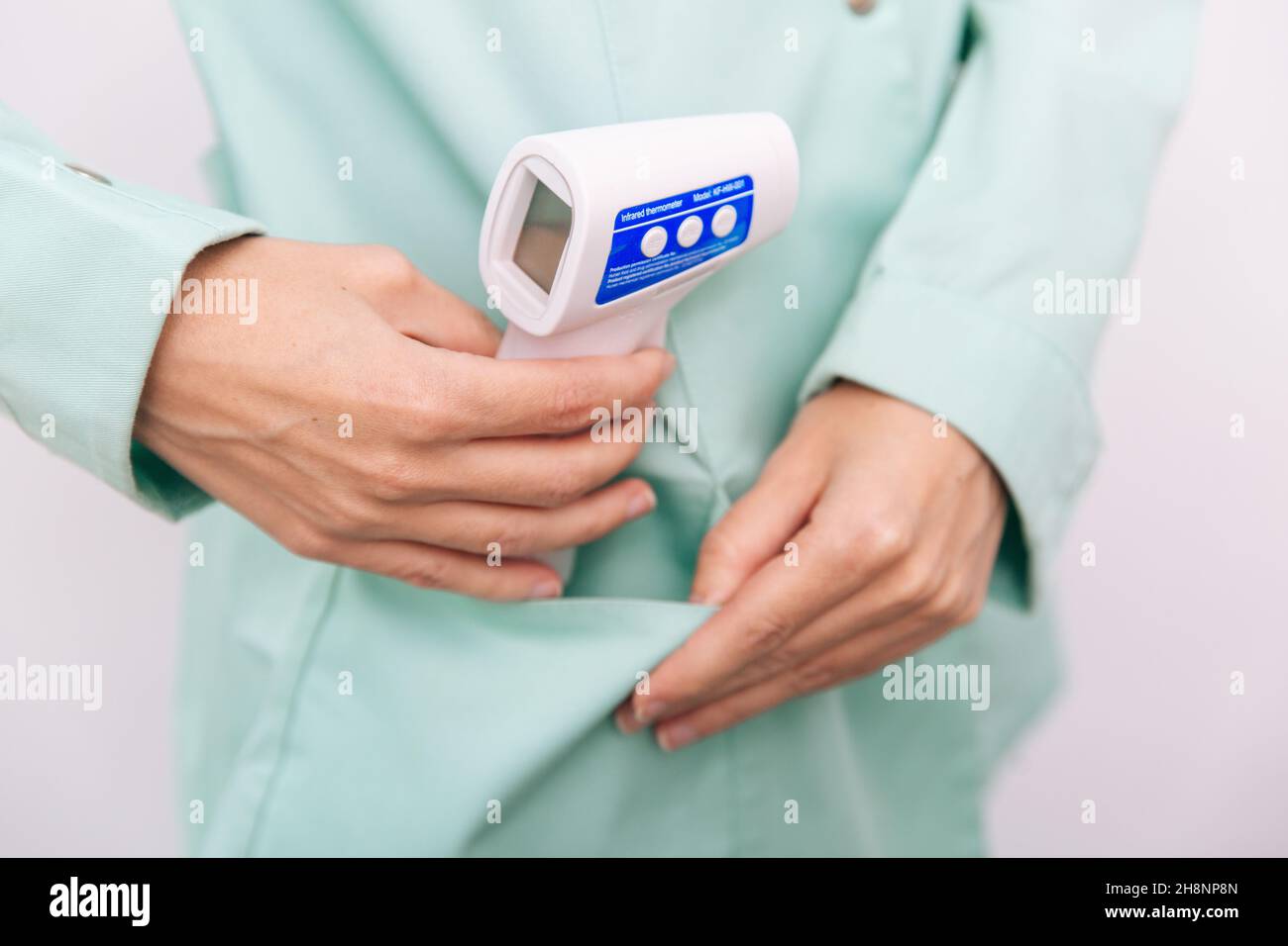 Temperature measurement gun in doctor hands. Close-up shot of doctor ...