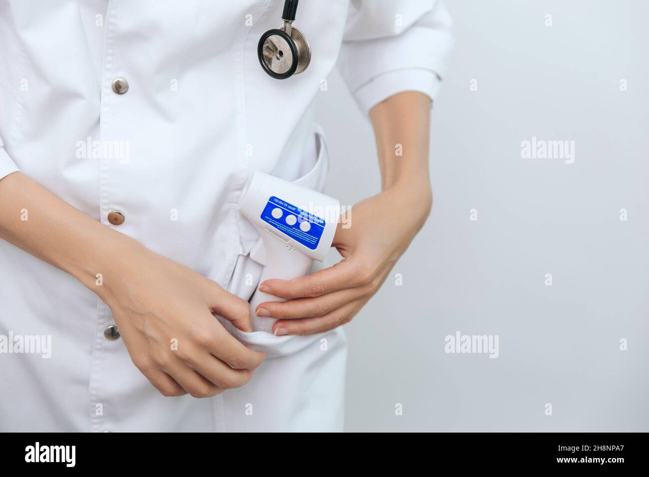 Temperature measurement gun in doctor hands. Close-up shot of doctor ...