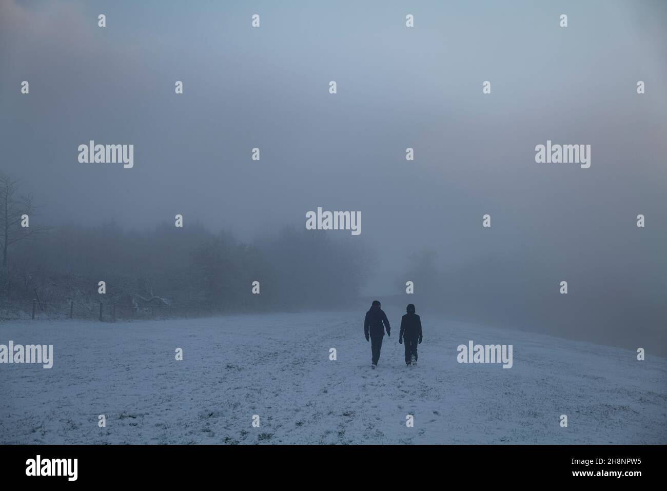 Couple walking on the Ribble Way path in winter, Clitheroe, Ribble ...