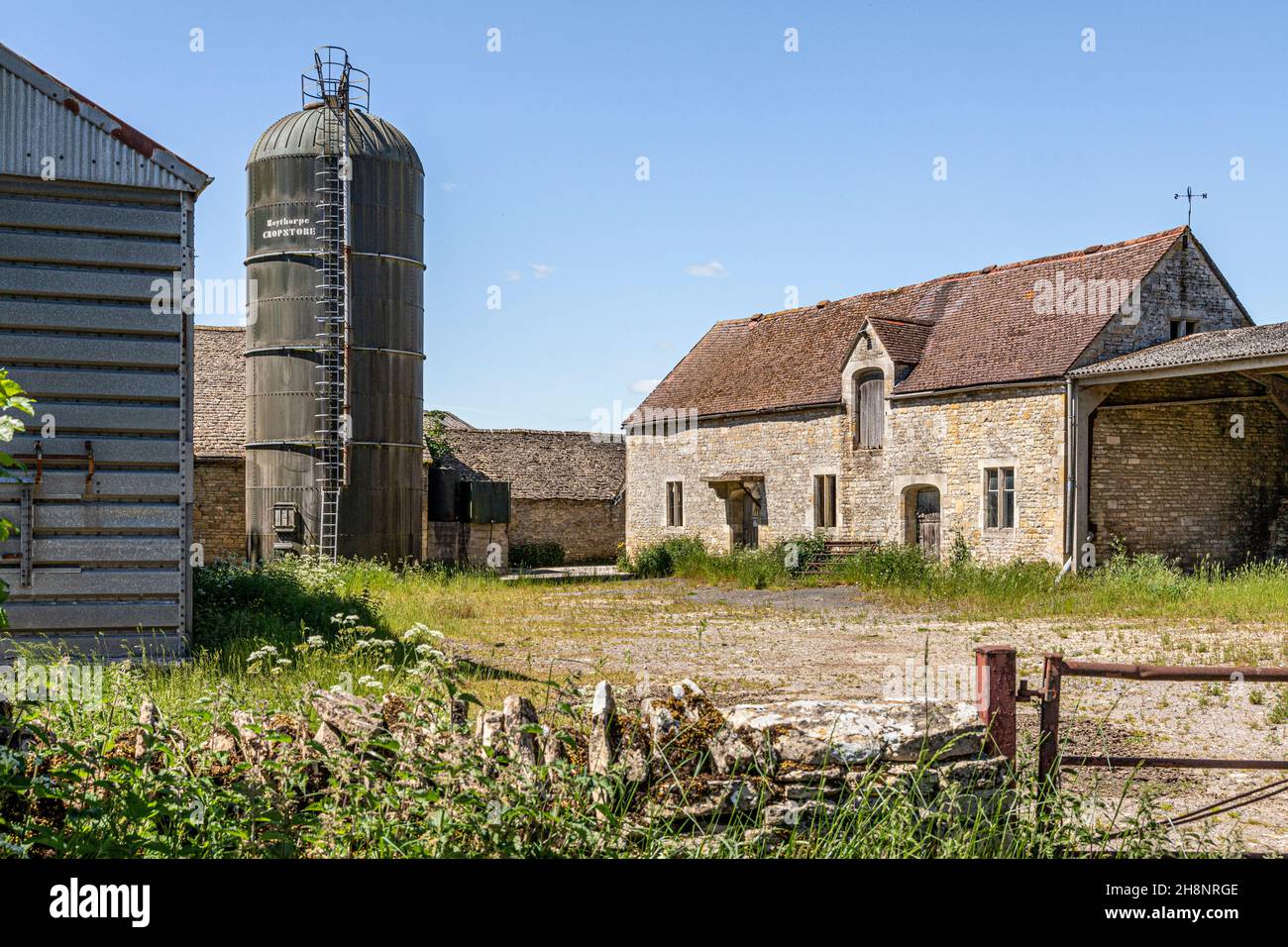 A modern silo and an old barn in the Cotswold village of Turkdean ...