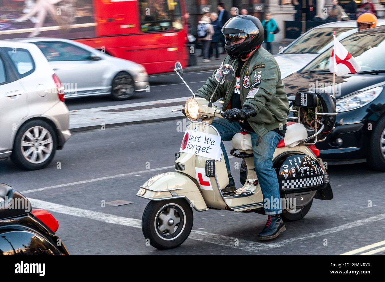 Motor scooter rider in London on Remembrance Sunday with Lest we Forget ...