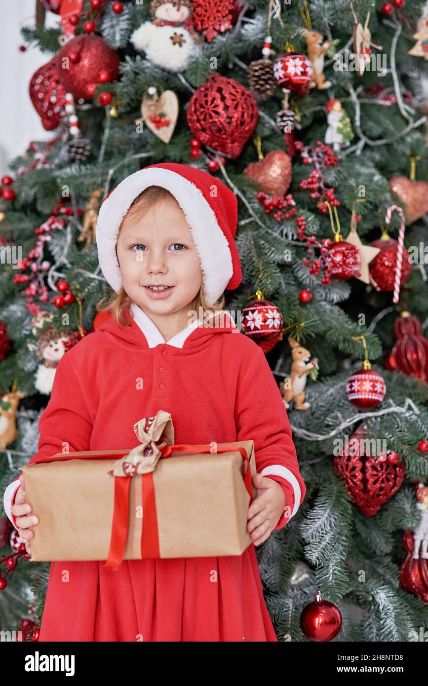 Happy excited girl child holding christmas gift box. Happy little girl ...