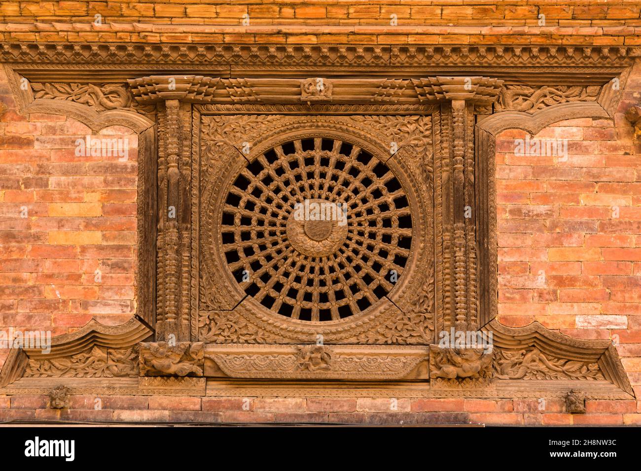 Intricately carved wooden circular window in the Pujari Math in the ...