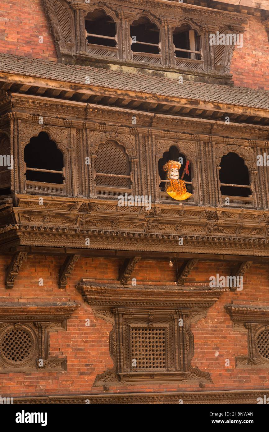 Mannequin figure of a Hindu priest in an intricately-carved window in ...