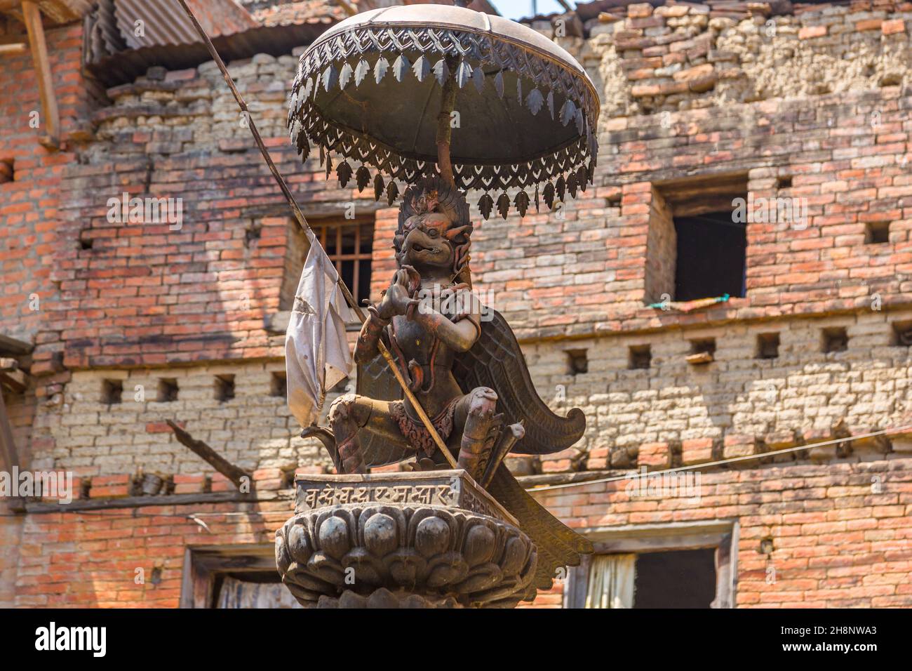 A bronze statue of the Hindu creature Garuda on pillar in the medieval ...