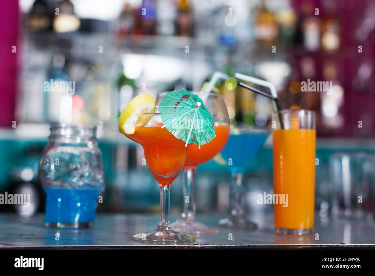 Cocktails with straws on the bar counter Stock Photo - Alamy