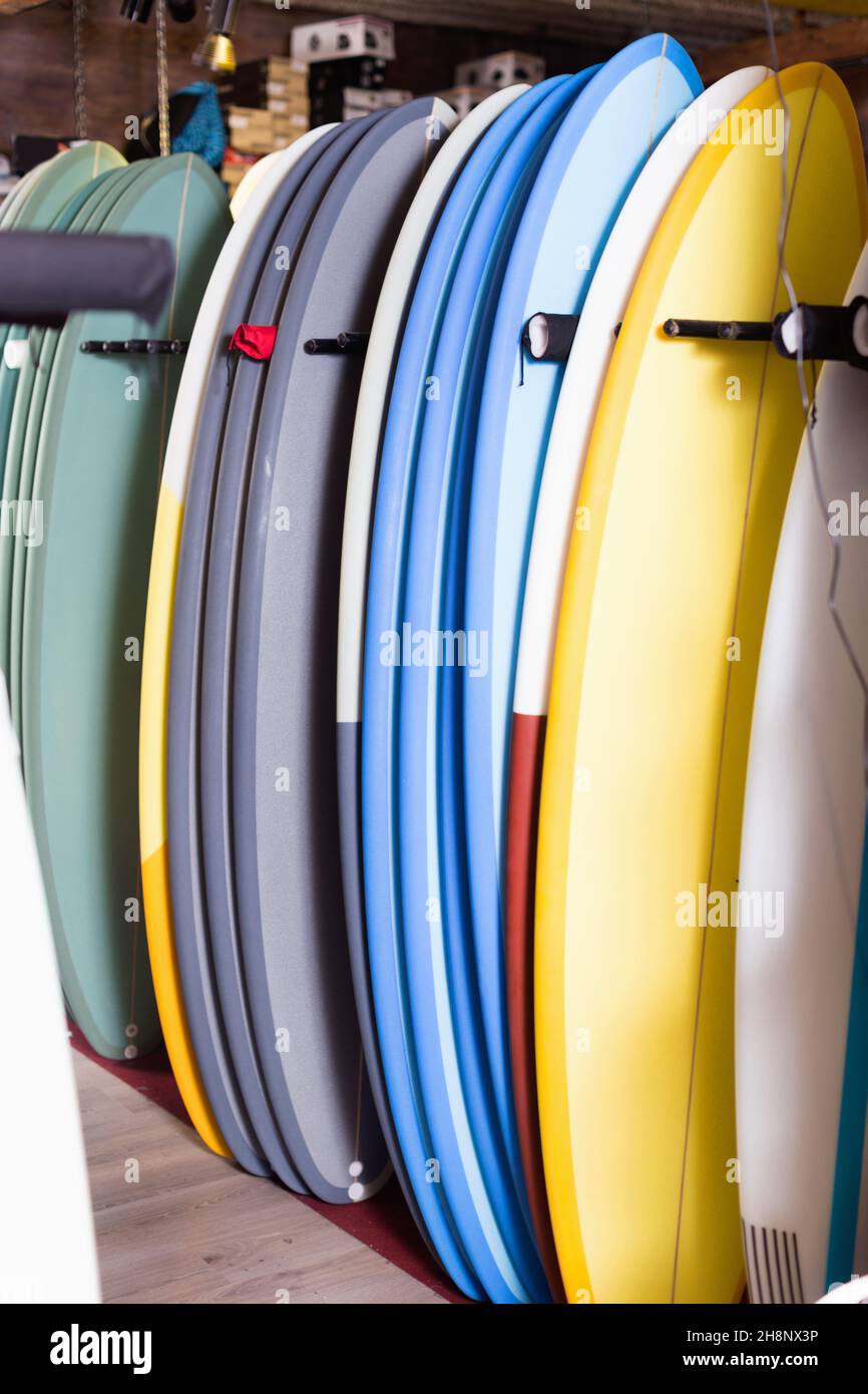Image of colorful surfboard standing in store Stock Photo - Alamy