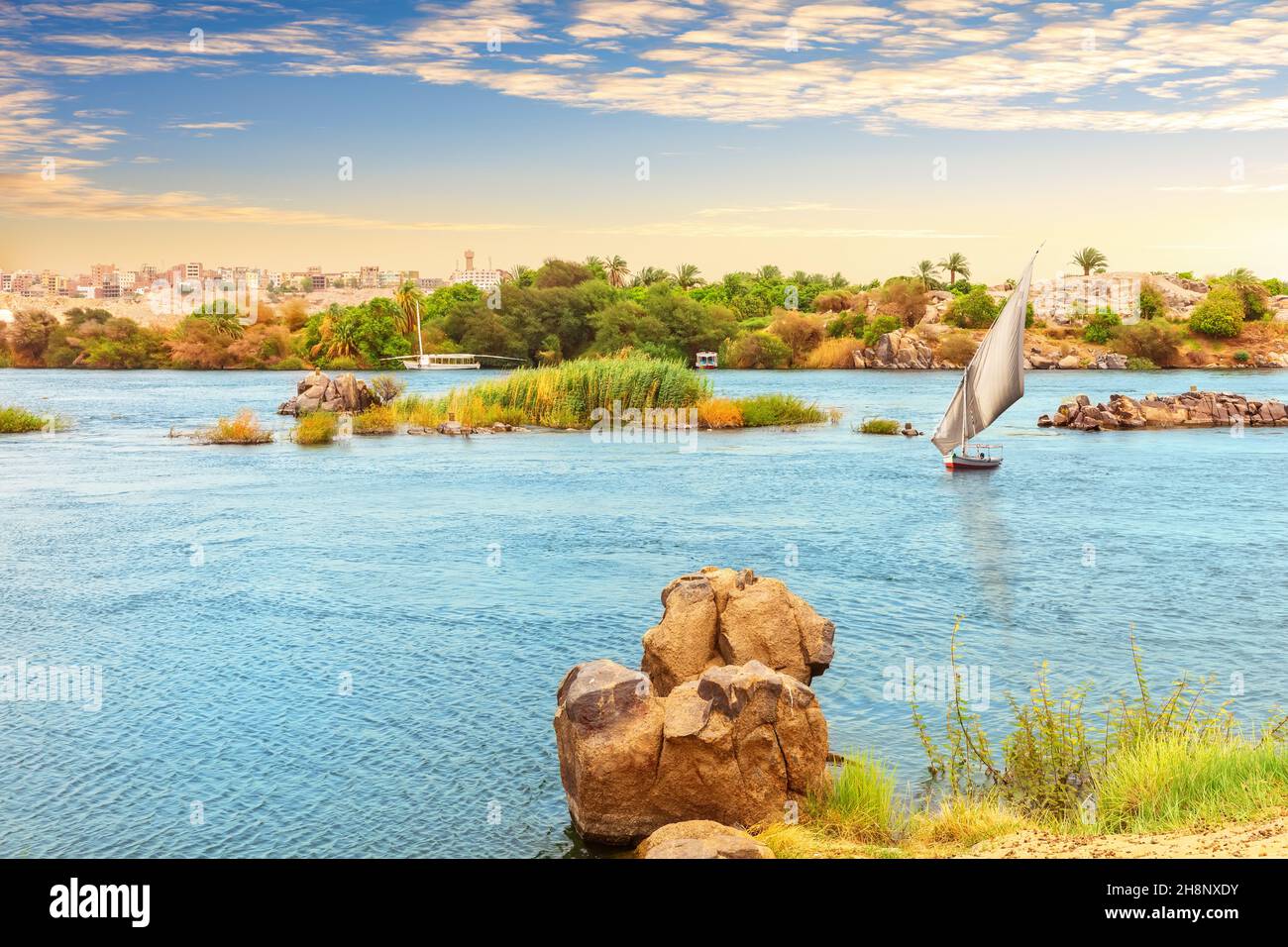 View on the Nile with a boat from the Nubian village, Aswan, Egypt ...