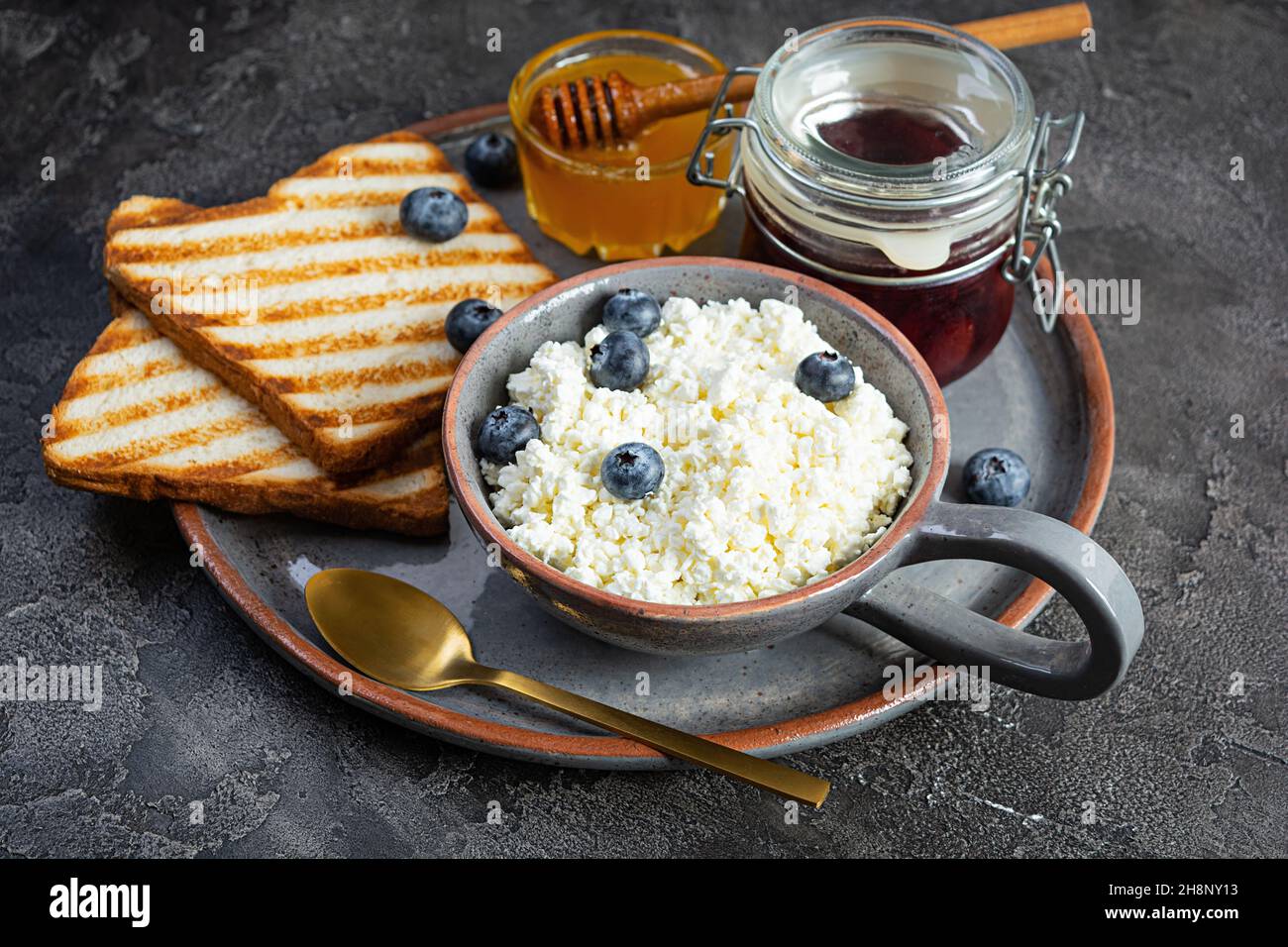 Delicious cottage cheese with blueberry, honey, strawberry jam and ...